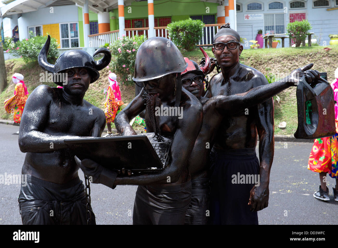 Grenada’s Caribbean annual carnival Jab Jab revelers have painted their ...