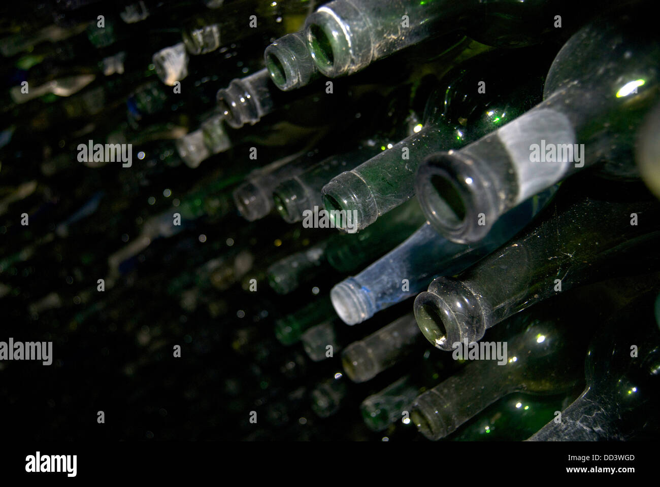 Multi-coloured recycled glass bottles built into unusual building at ...