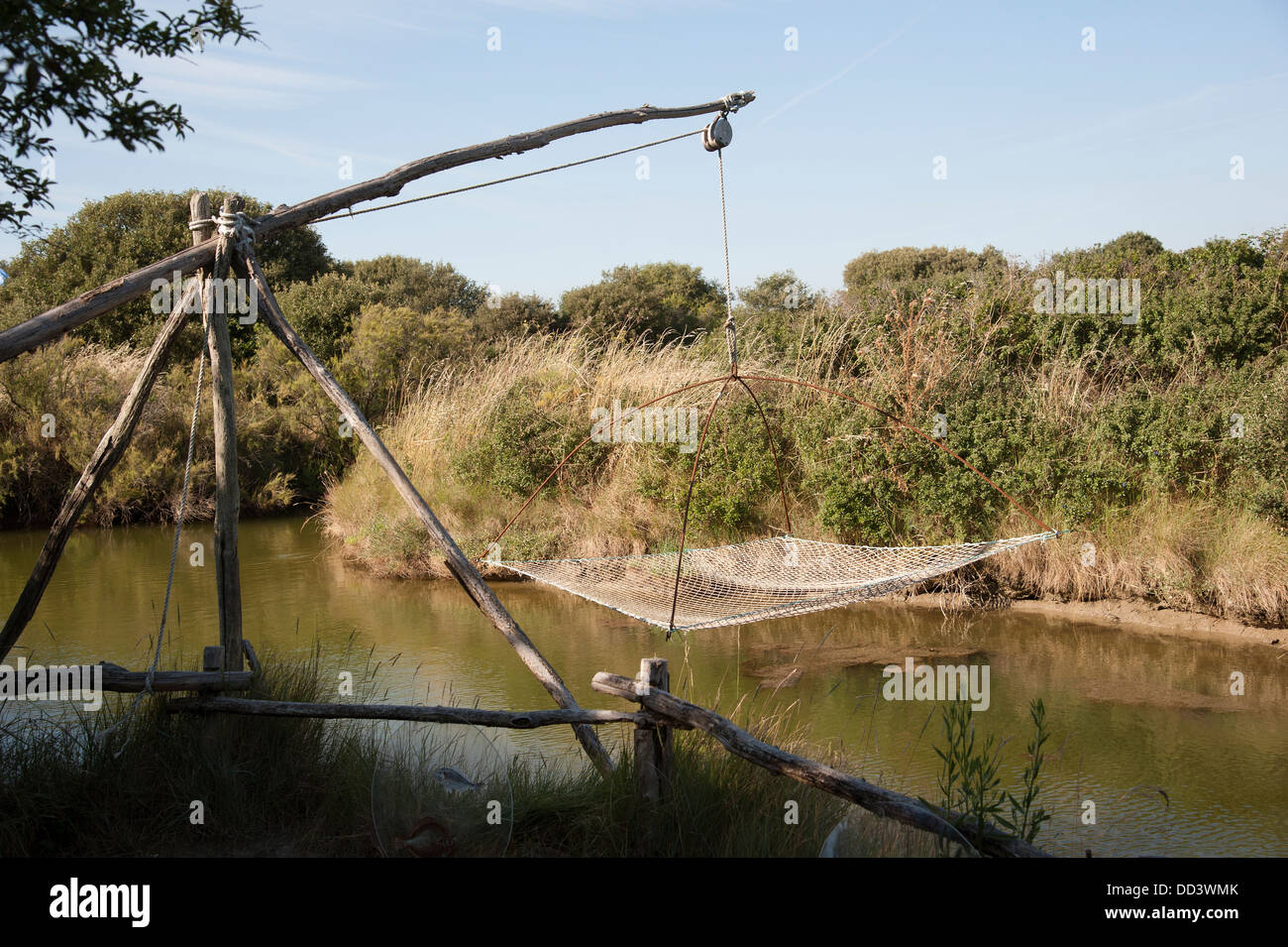 Large fishing net suspended over surface water on a French river Stock ...