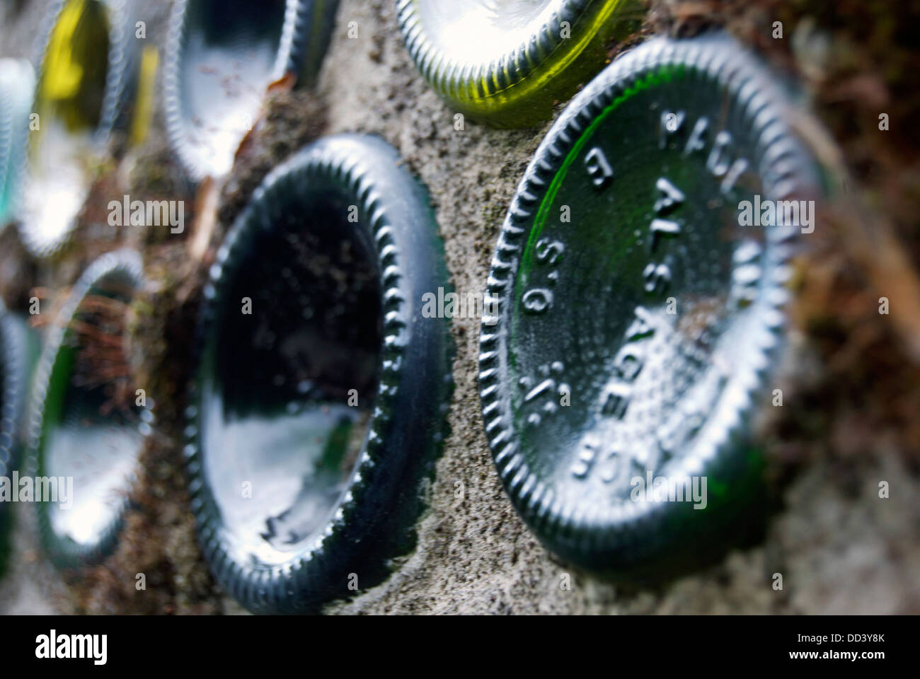Base of glass bottles that have been built into a wall Stock Photo - Alamy