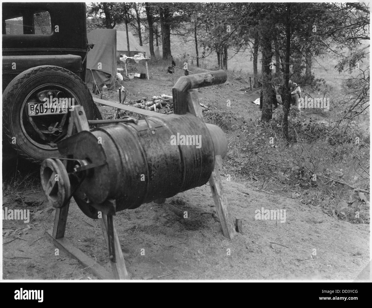 A wild rice hulling machine is set up at a camp, indicating an active ...