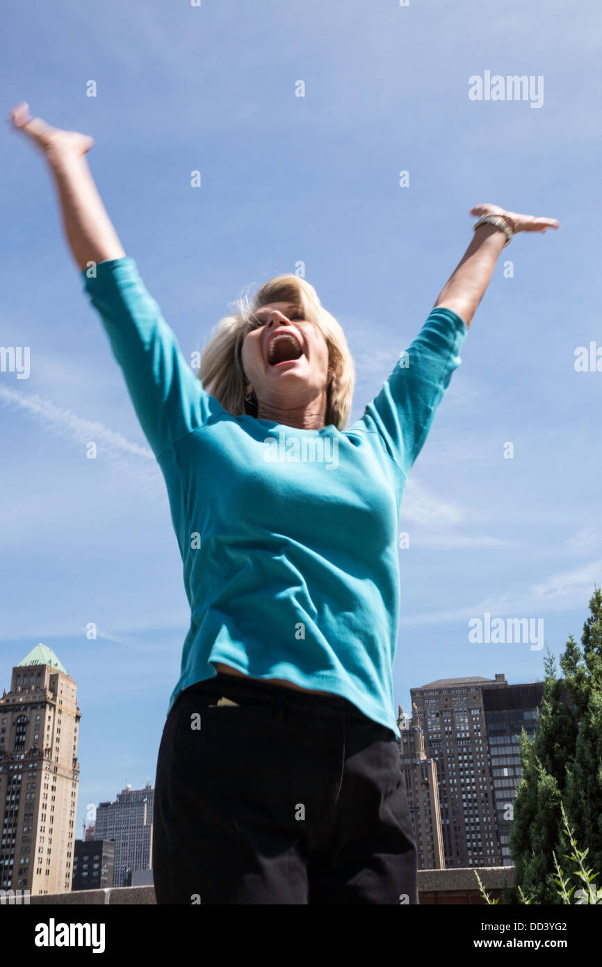 Happy Mature Woman Jumping for Joy Stock Photo - Alamy