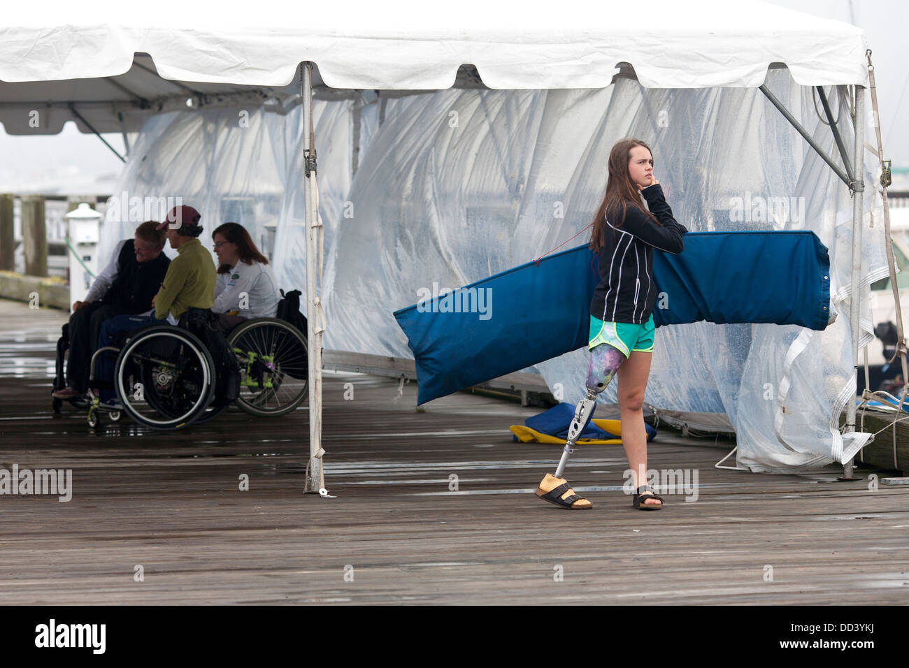 An amputee sailor walks carrying sail bag at a disabled sailing regatta ...