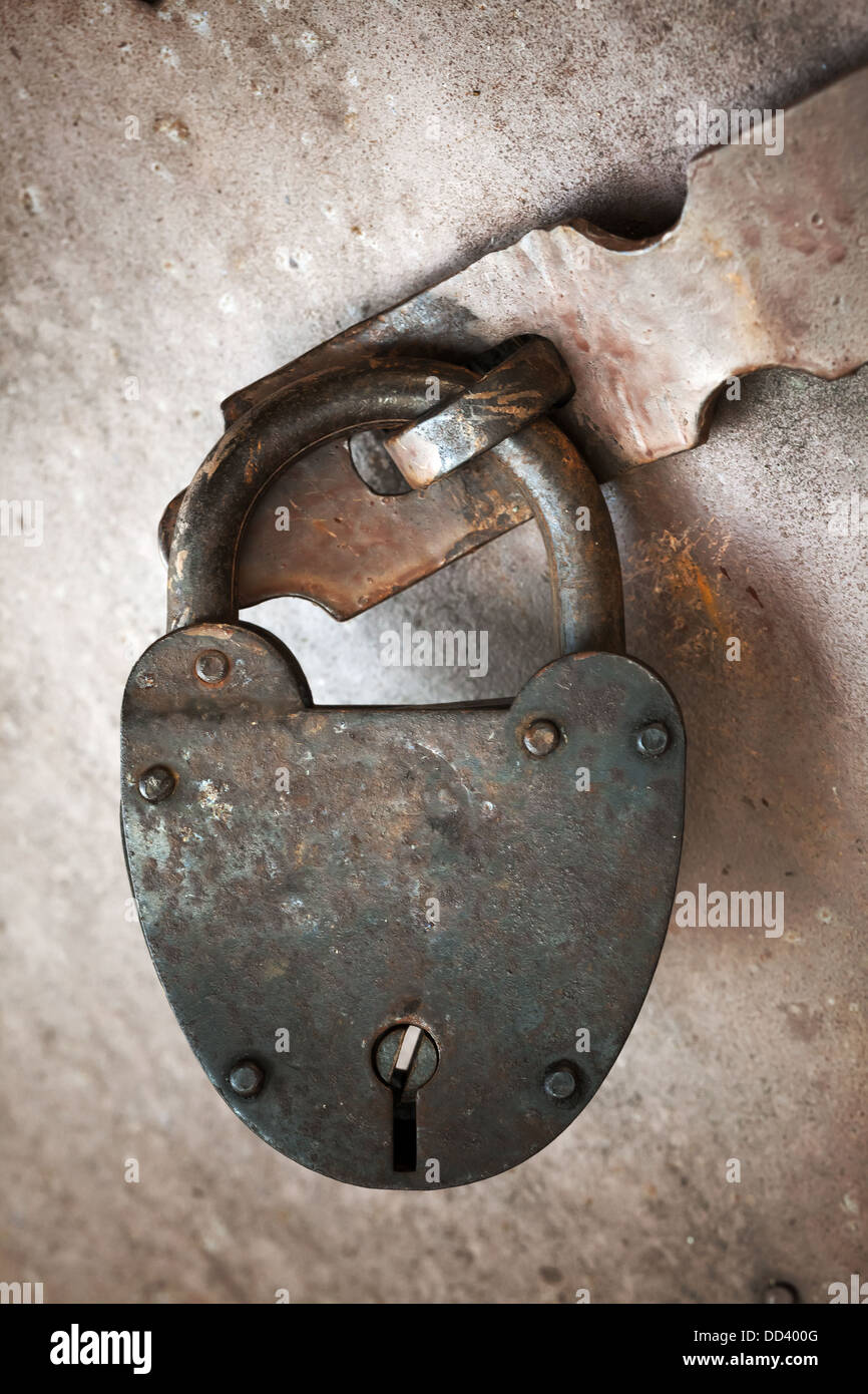 Old rusted lock hangs on metal door. Close-up photo Stock Photo - Alamy