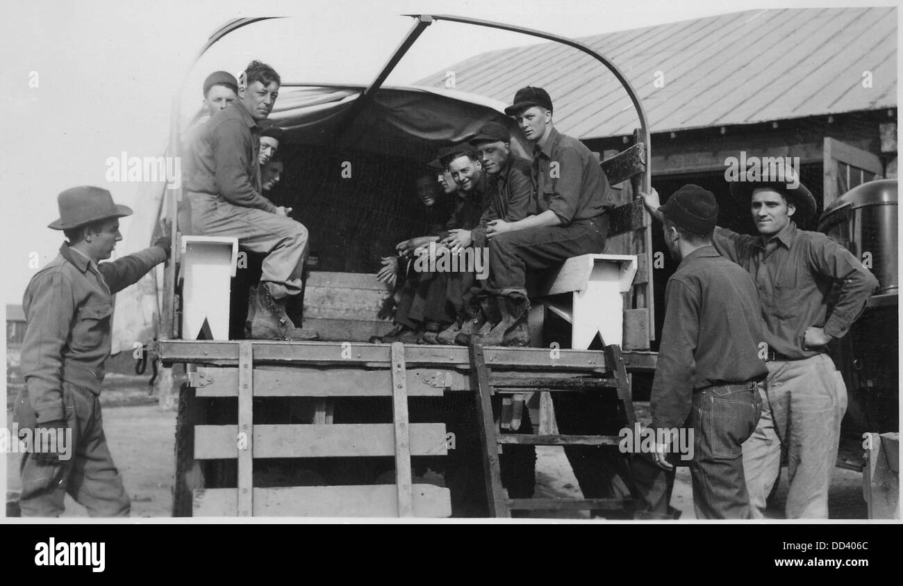 A work crew loads into a truck, preparing to head to their job site ...