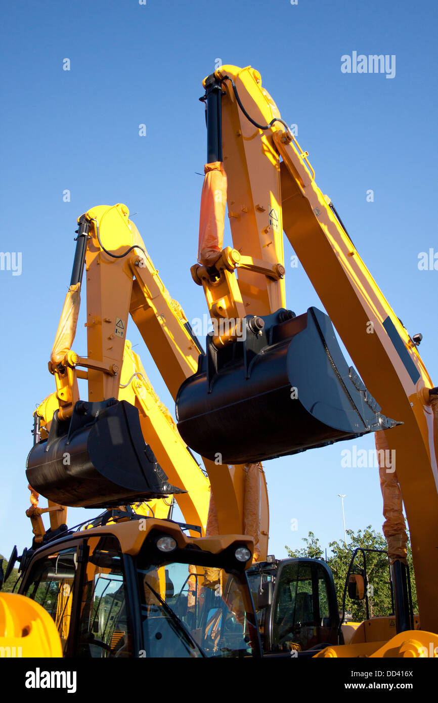 Two excavators parked next to each other Stock Photo - Alamy