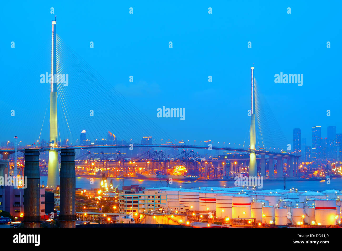 gas tank and highway bridge in sunset moment Stock Photo - Alamy
