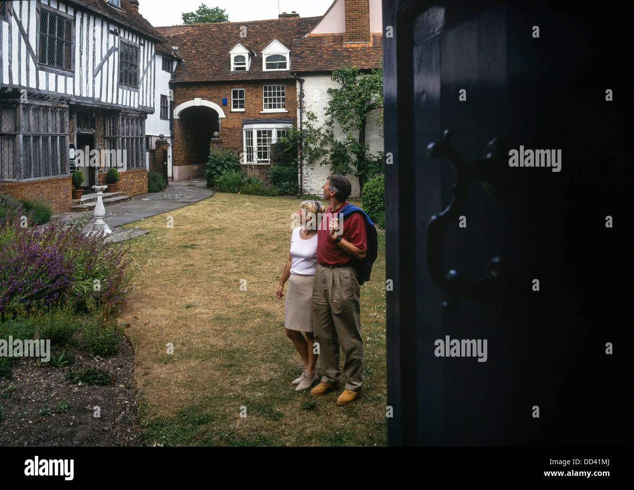 An adult couple outside the Tymperleys Clock Museum, Colchester, Essex ...