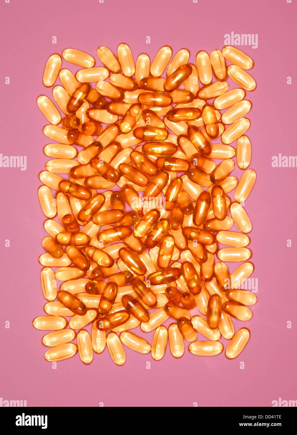 A group of amber colored capsule pills forming a rectangular shape on a ...