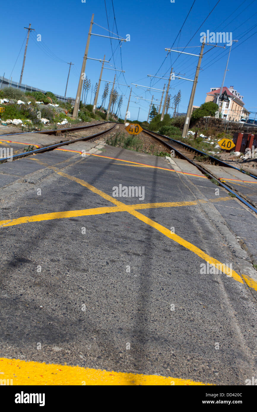 Train tracks at a road crossing Stock Photo - Alamy