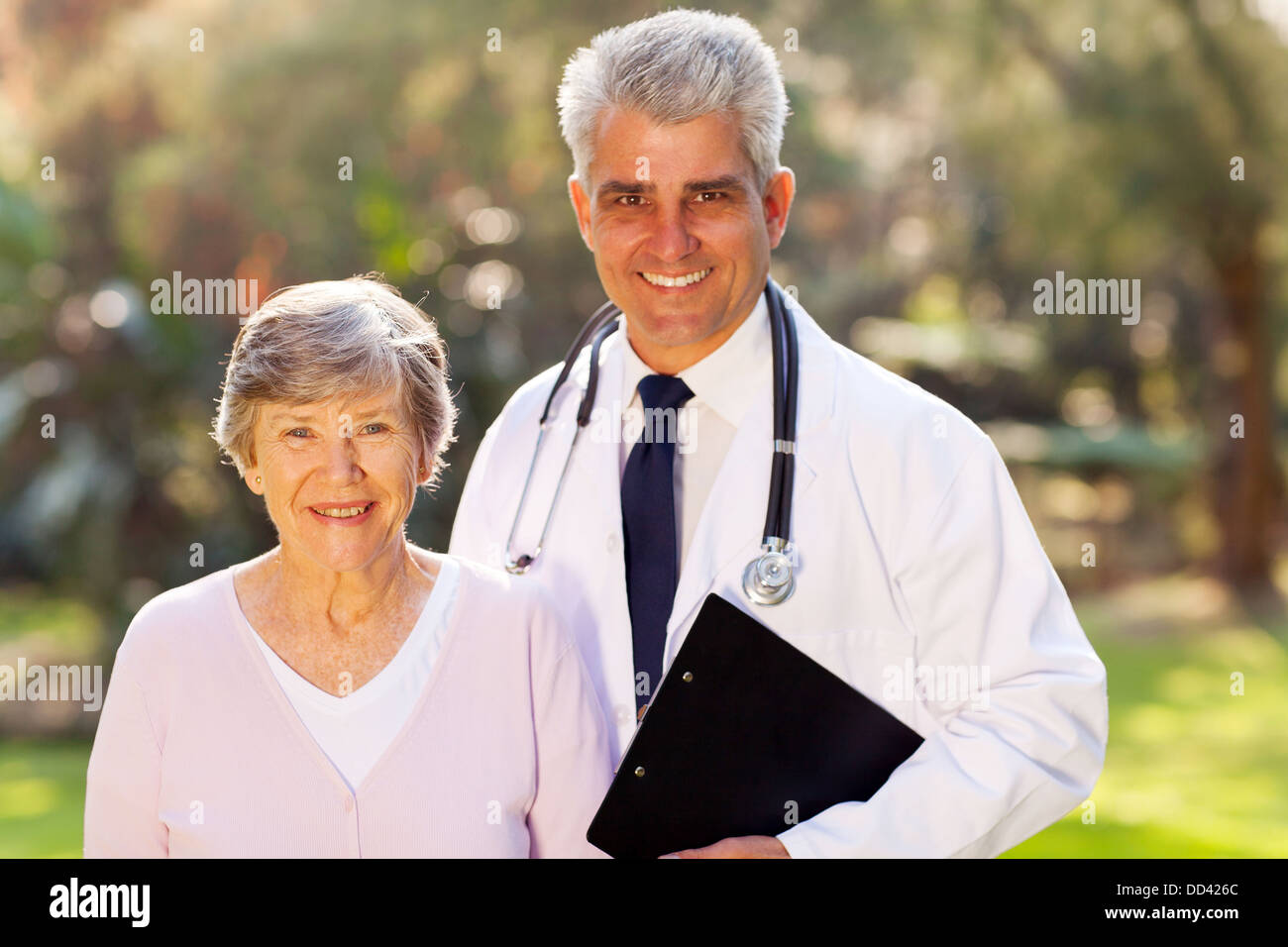 happy middle aged doctor and senior patient outdoors Stock Photo - Alamy