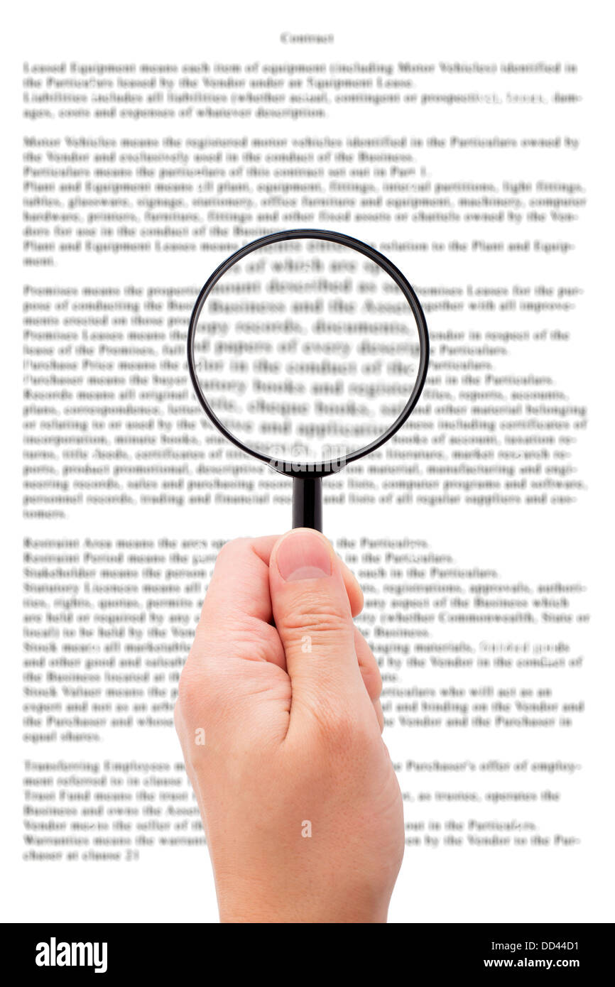 Hand holding magnifying glass reading document Stock Photo - Alamy