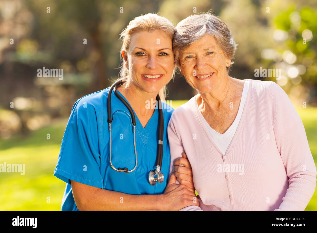 mid age medical nurse and senior patient outdoors Stock Photo - Alamy