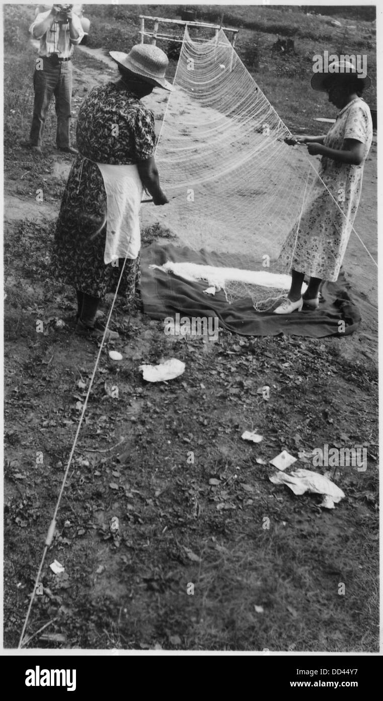 Women are shown making fishing nets, a traditional craft essential for ...