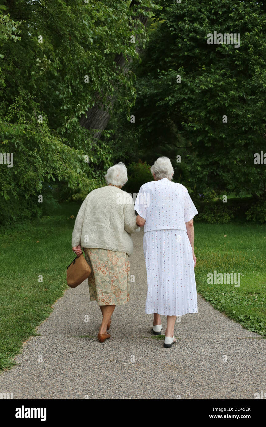 Two women walking on park hi-res stock photography and images - Alamy