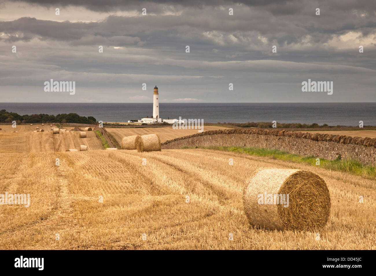 Barns Ness Lighthouse Along The Coast And Hay Bales In A Field In The ...