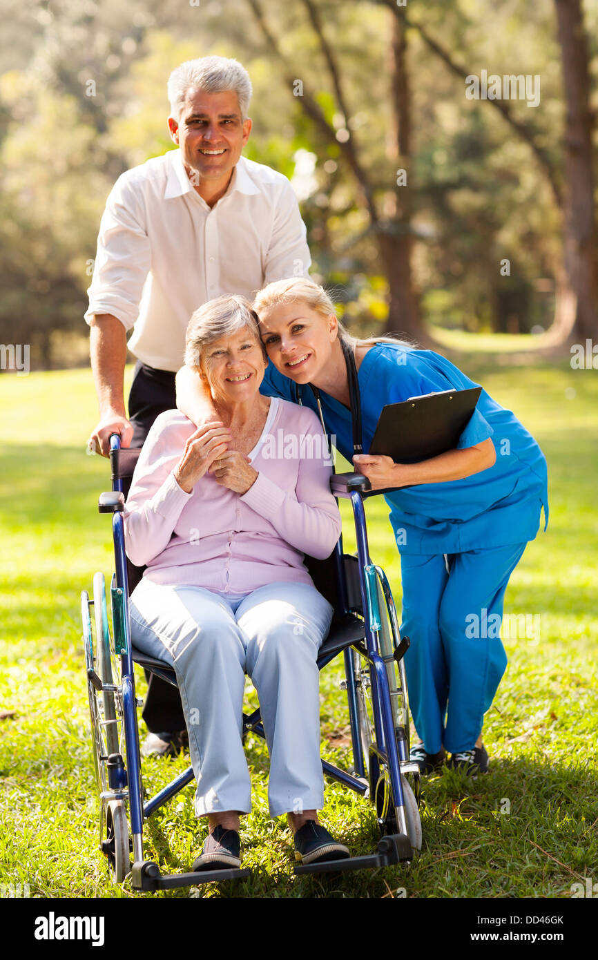 caring nurse hugging senior patient outdoors Stock Photo - Alamy