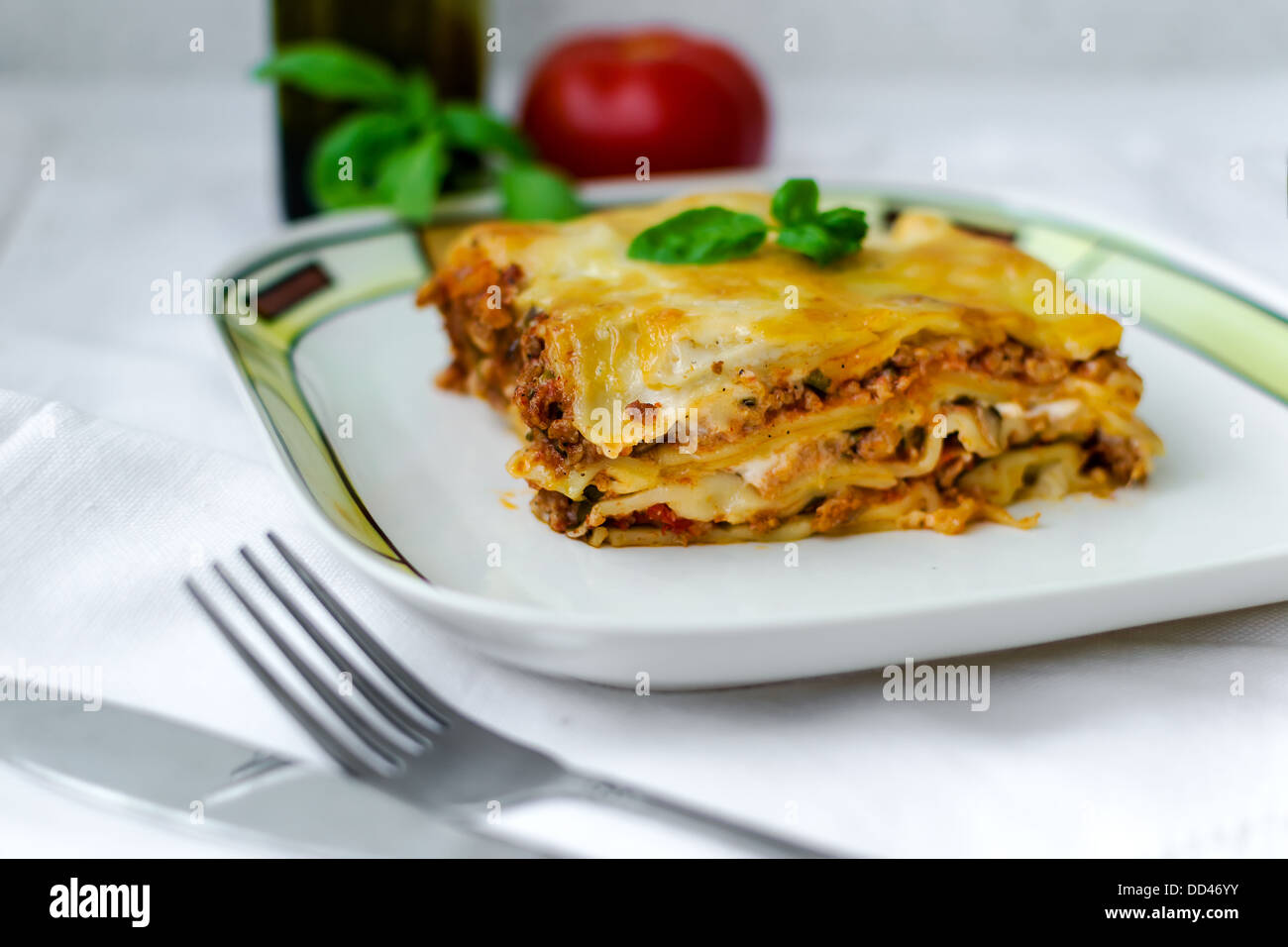 Piece of lasagna bolognese on a white plate Stock Photo - Alamy