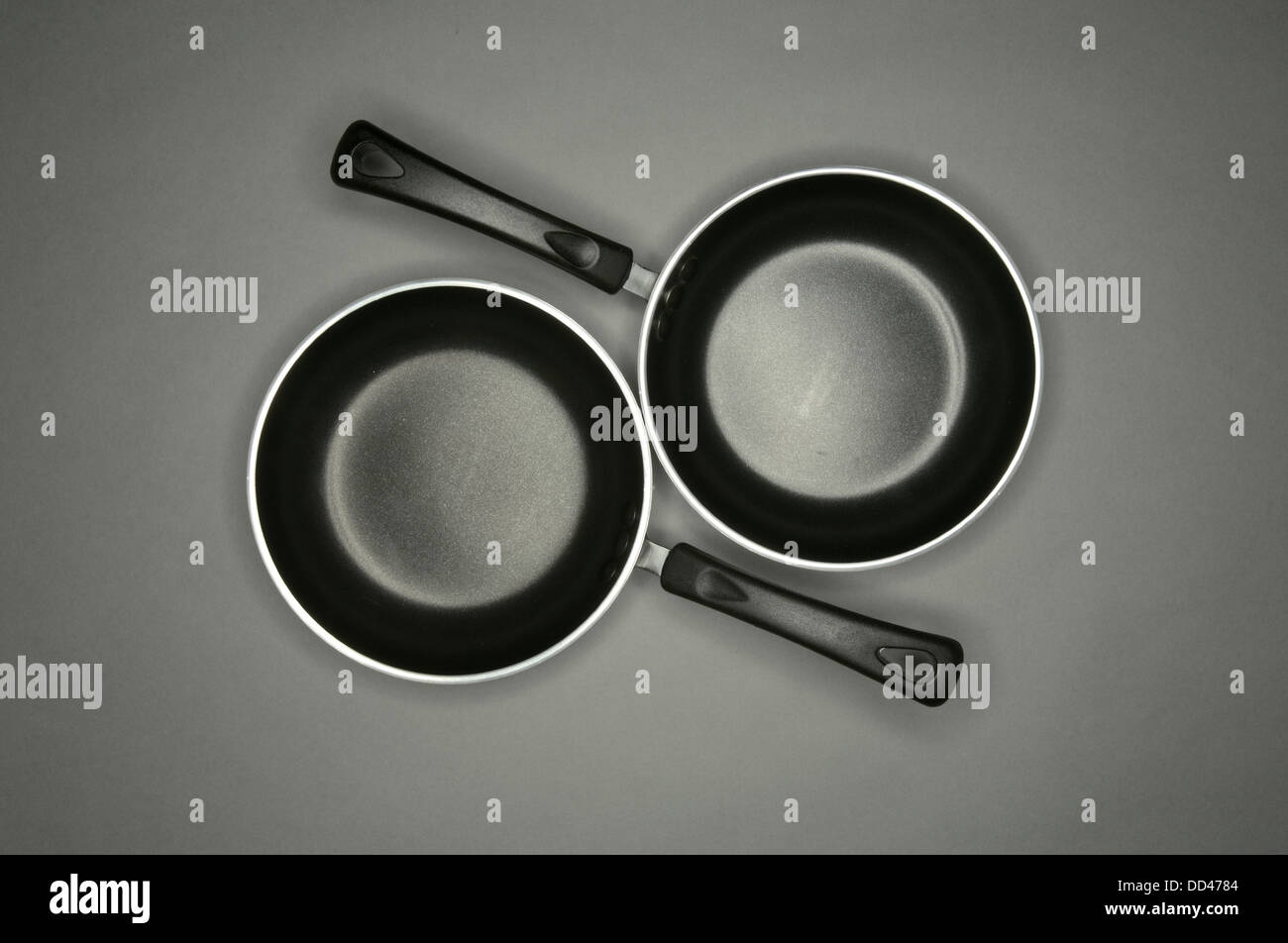 Two kitchen non-stick frying pans Stock Photo - Alamy