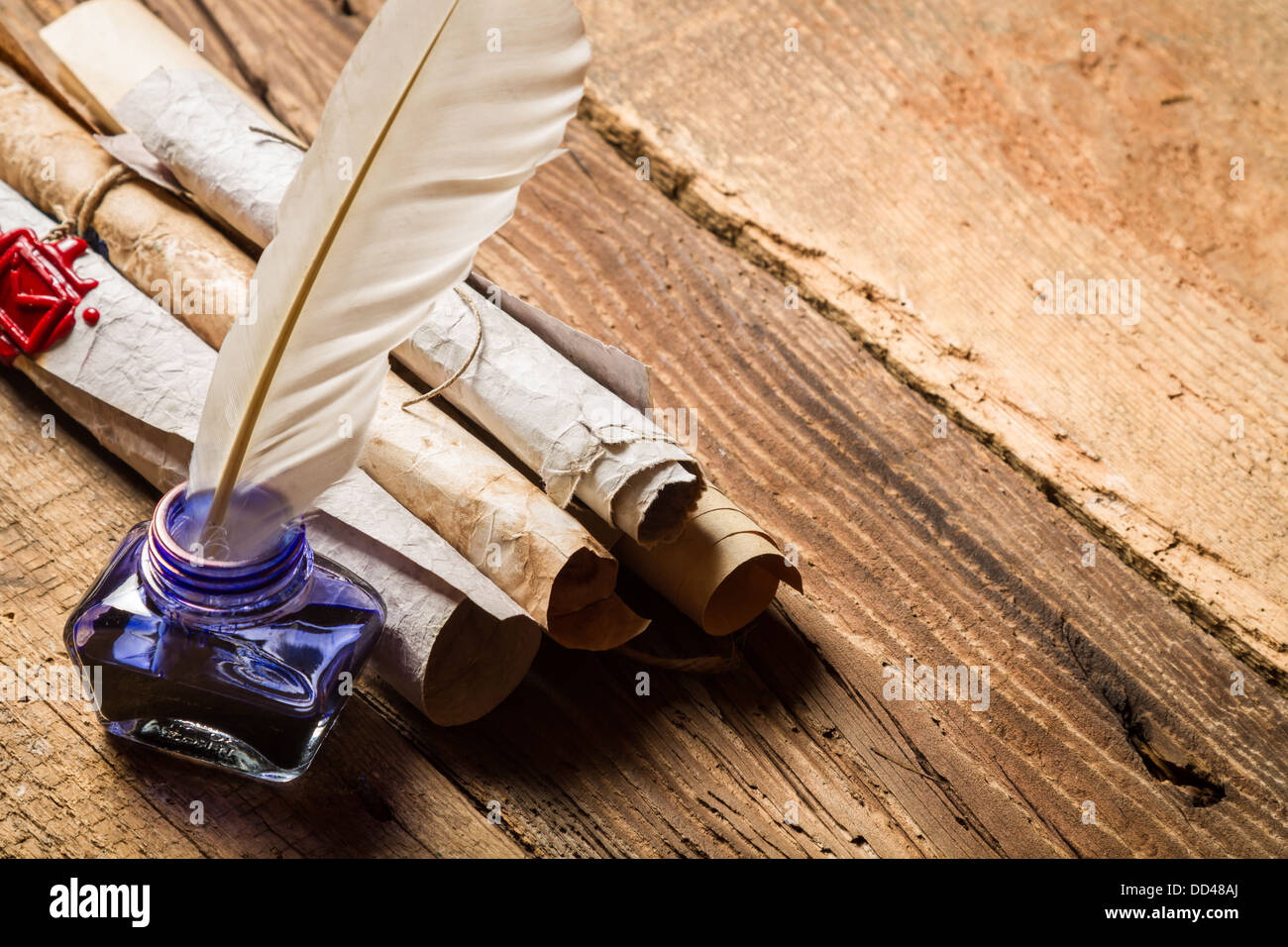 Old rolls of paper and blue ink in the inkwell Stock Photo - Alamy