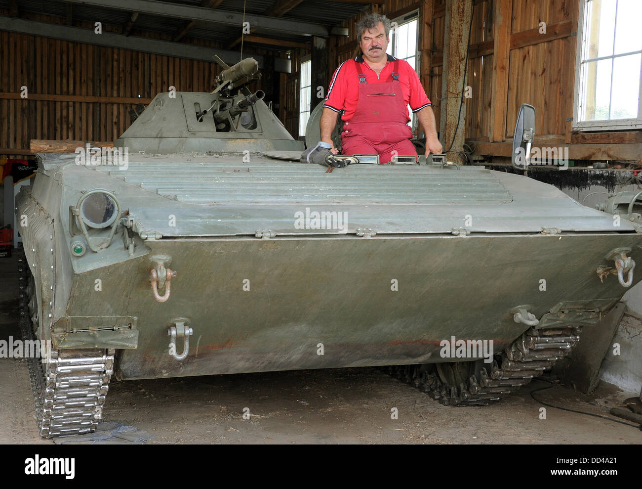 Collector Paul Benzin sits in a Czech tank of type BMP OT-90 in ...