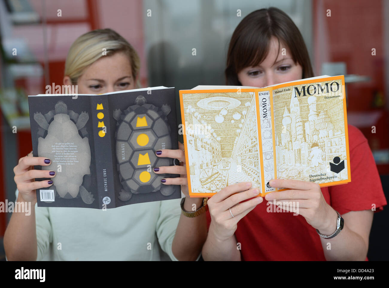 Two women read hi-res stock photography and images - Alamy