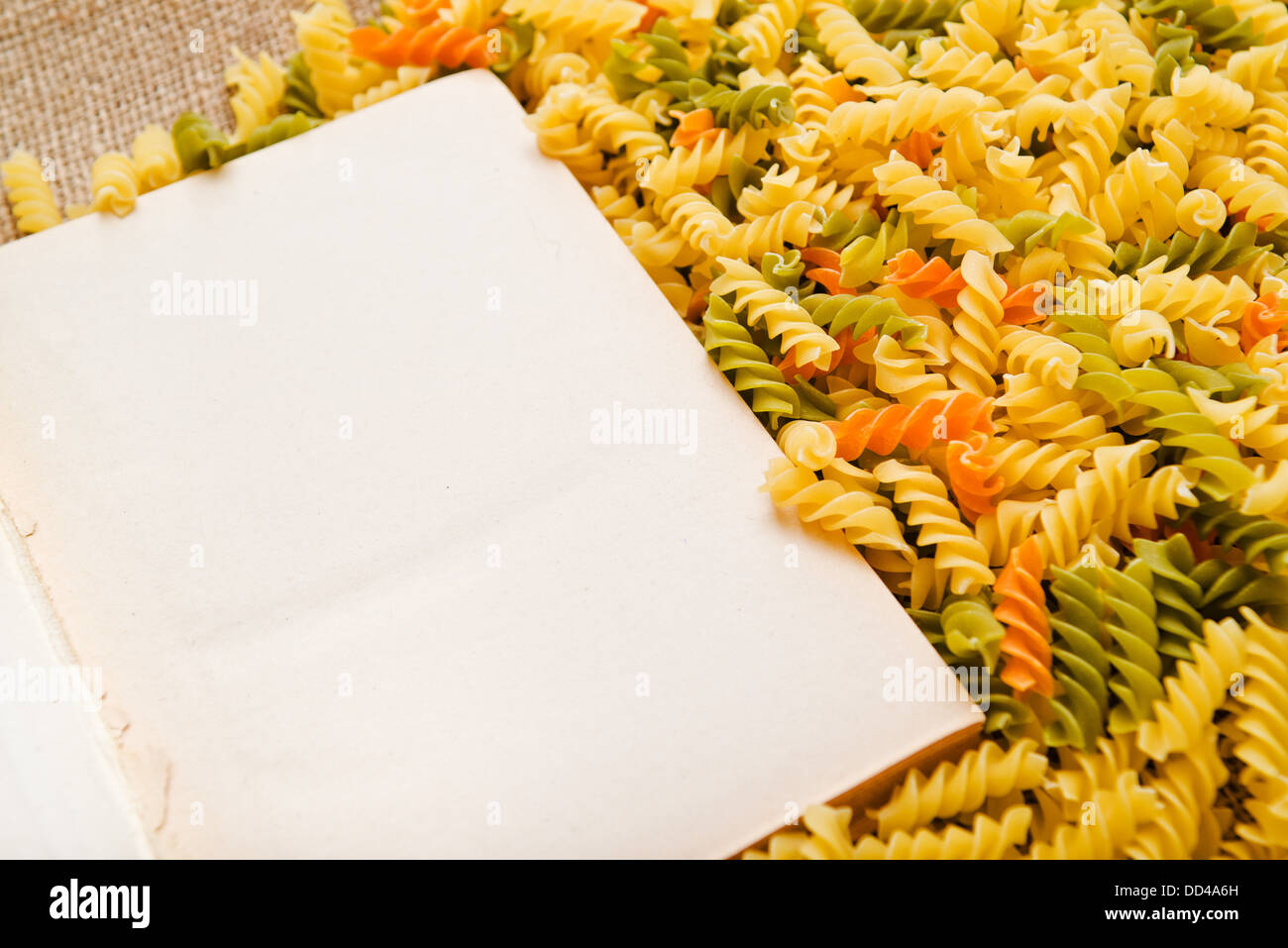 Italian fusilli or rotini and open recipe book with blank page Stock ...
