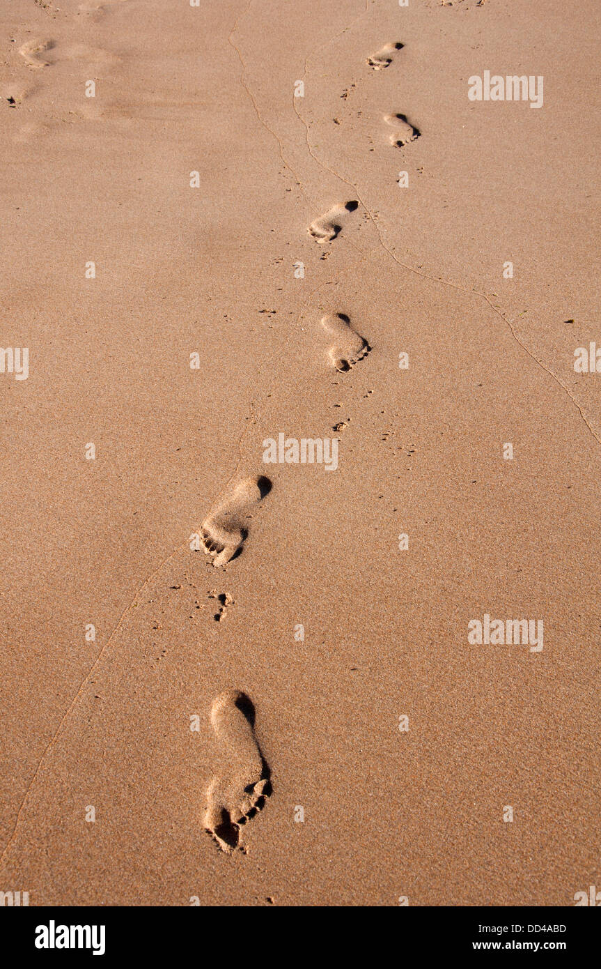 Footsteps in the beach sand Stock Photo - Alamy
