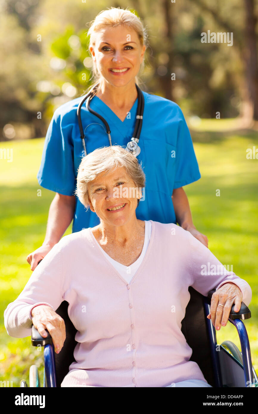 smiling medical nurse with disabled patient outdoors Stock Photo - Alamy