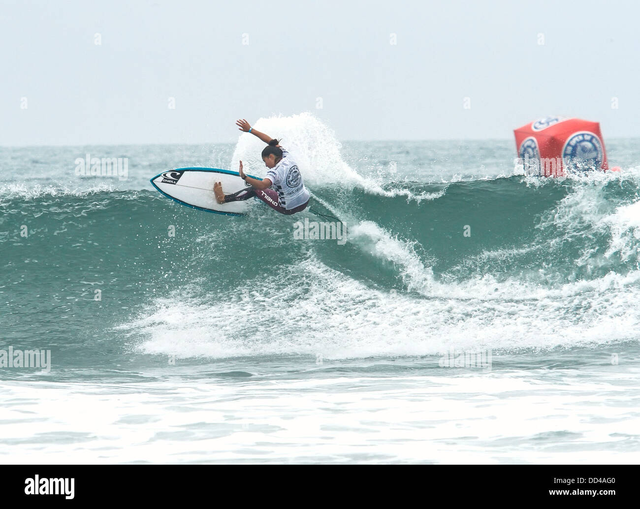 Female surfer competing in the US Open of Surfing competition Stock ...