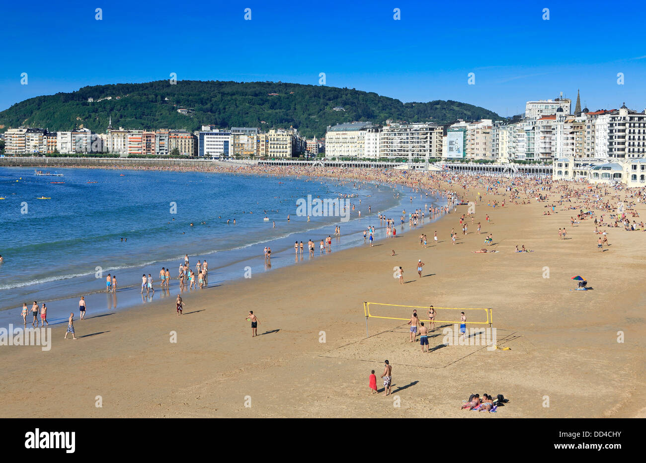 Summer crowd bathing and walking on Concha Beach in San Sebastian ...