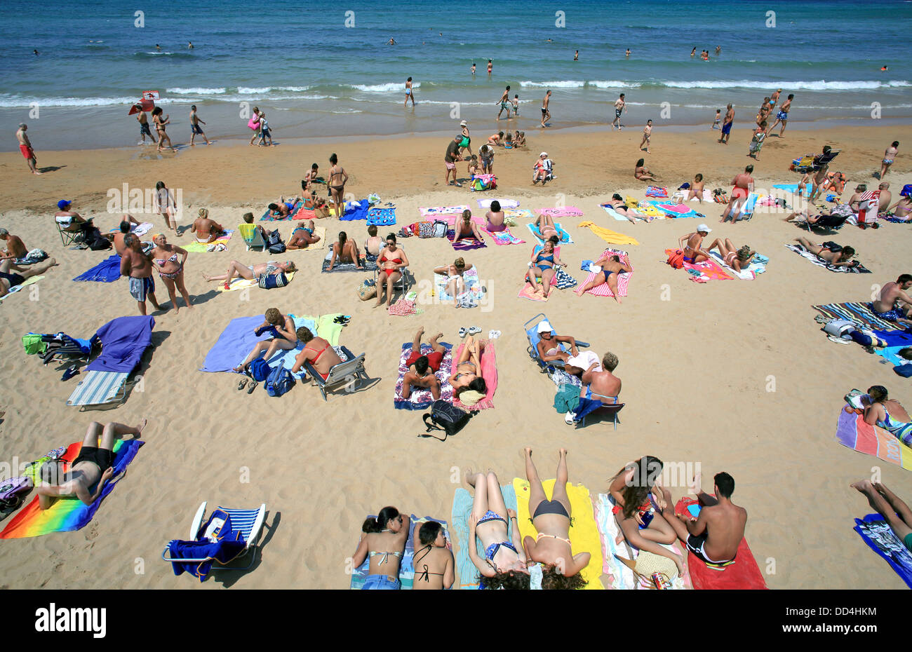 Crowded city beach during a hot summer day in Gijon, north Spain Stock ...