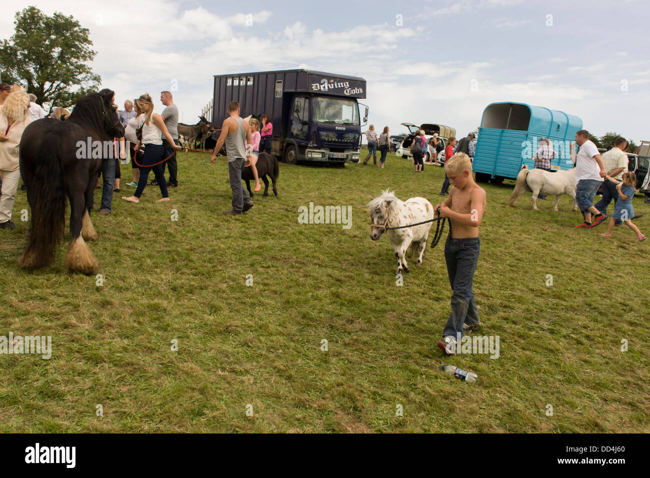 A young traveller tries out a Shetland pony at the ancient annual ...