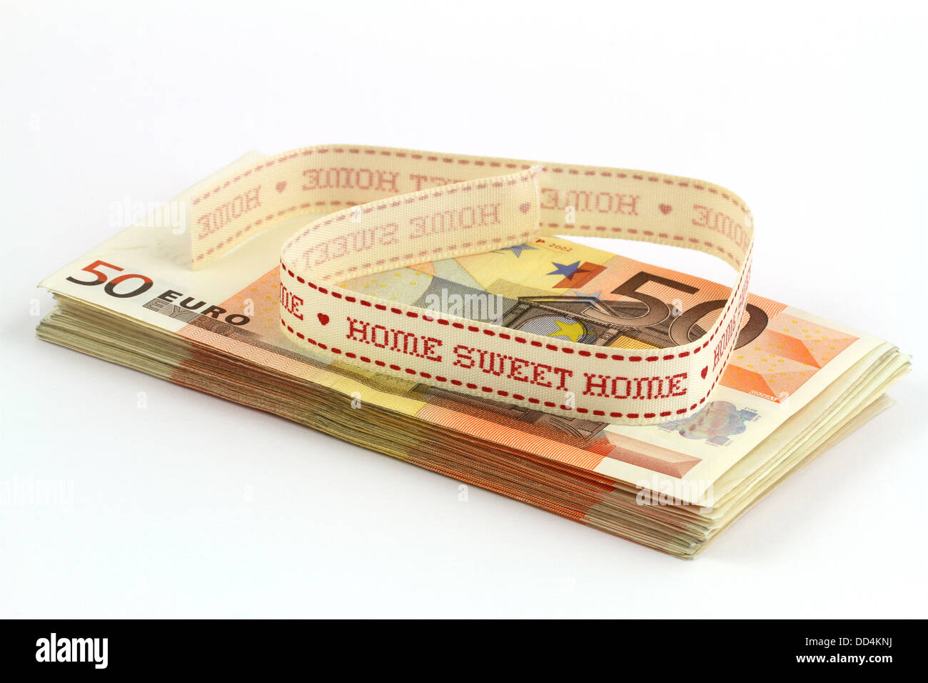 Stack of banknotes and "home sweet home" ribbon Stock Photo - Alamy