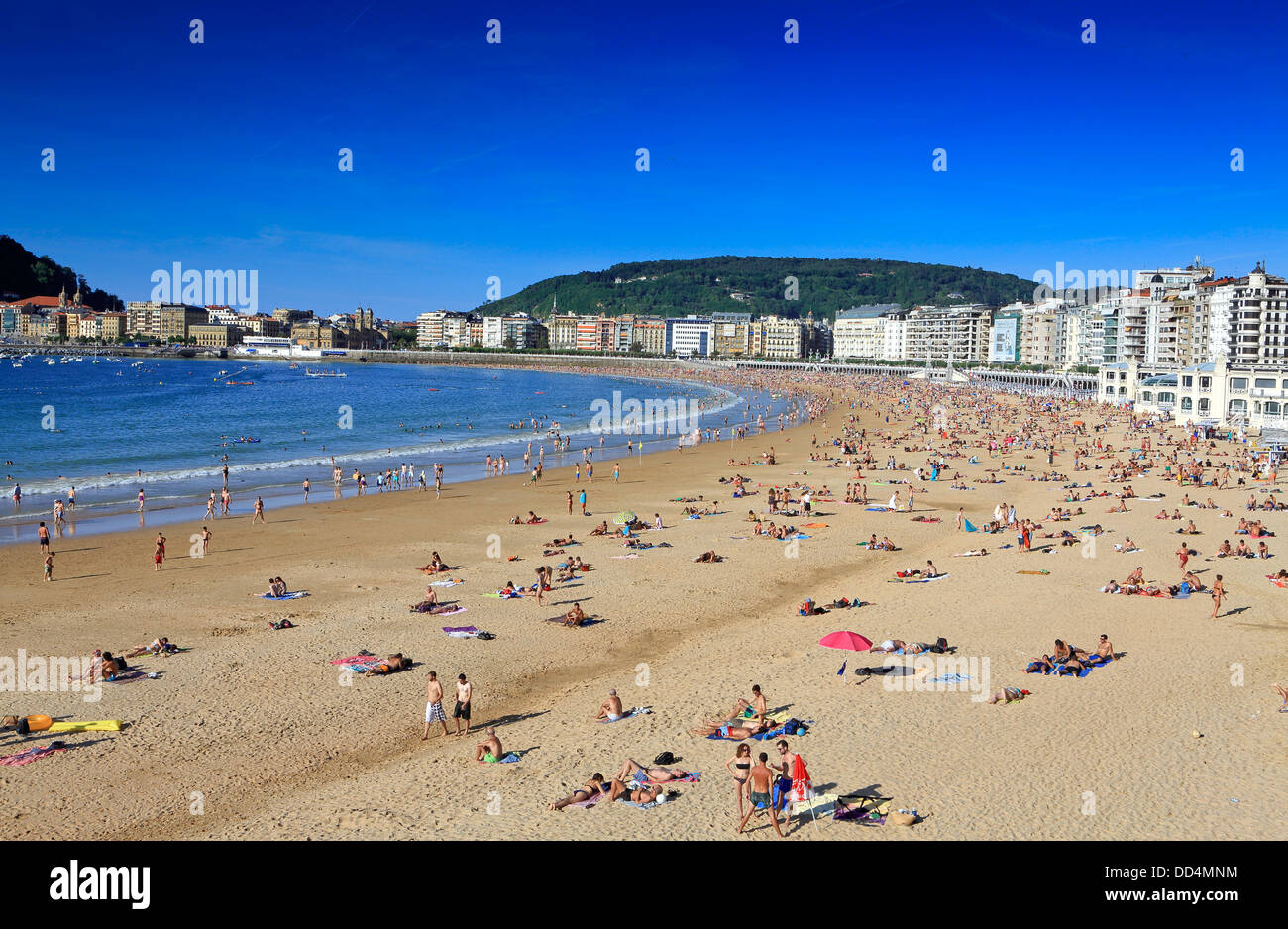 Summer crowd bathing and walking on Concha Beach in San Sebastian ...