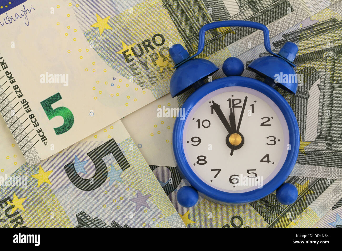 Time is money concept, miniature clock on banknotes Stock Photo - Alamy