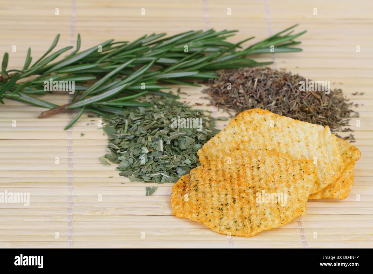 Baked potato crisps with Mediterranean herbs Stock Photo - Alamy
