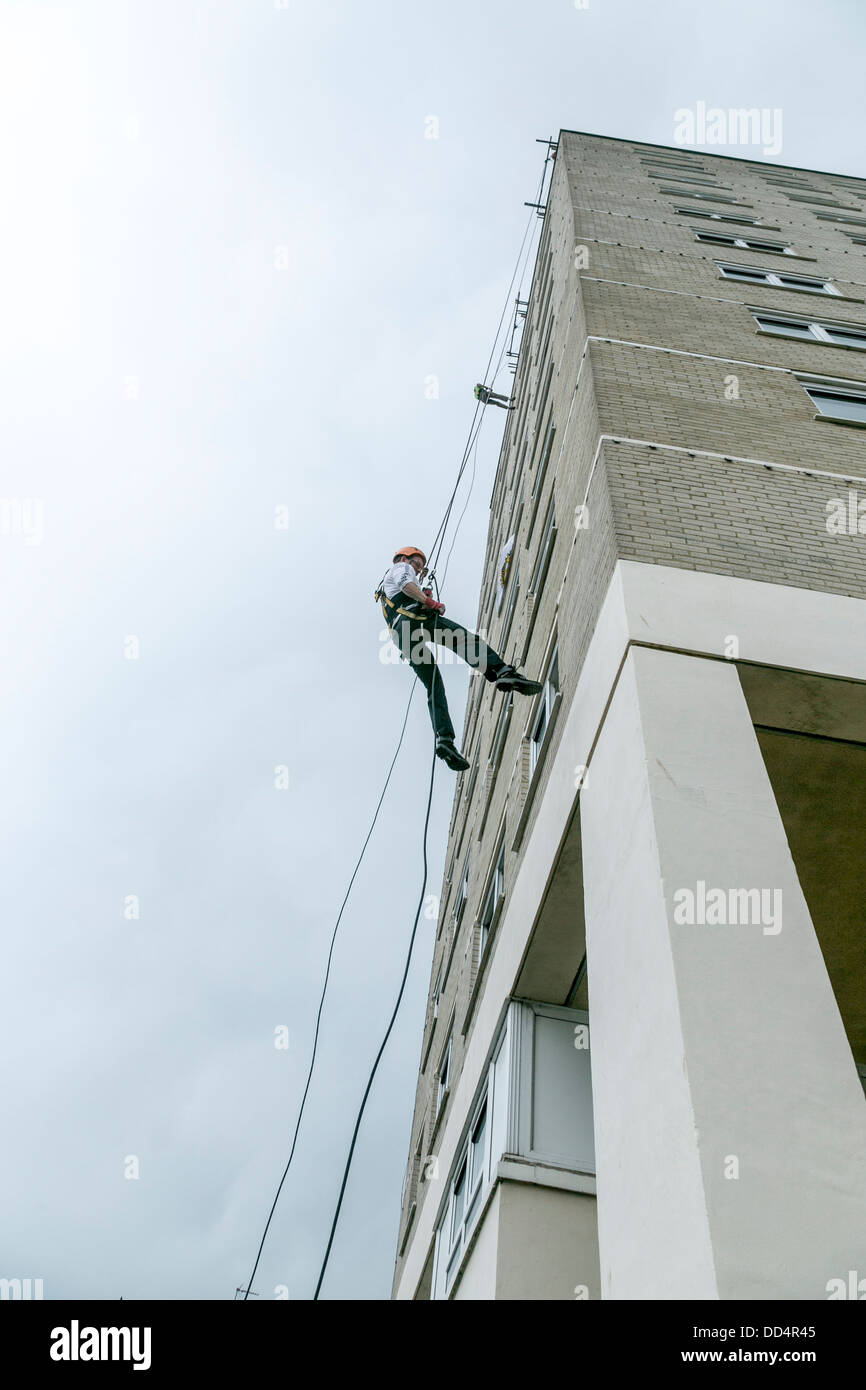 People Abseiling from a tower block for charity Stock Photo - Alamy