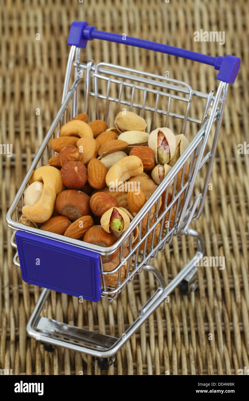 Mixed nuts in miniature shopping trolley Stock Photo - Alamy