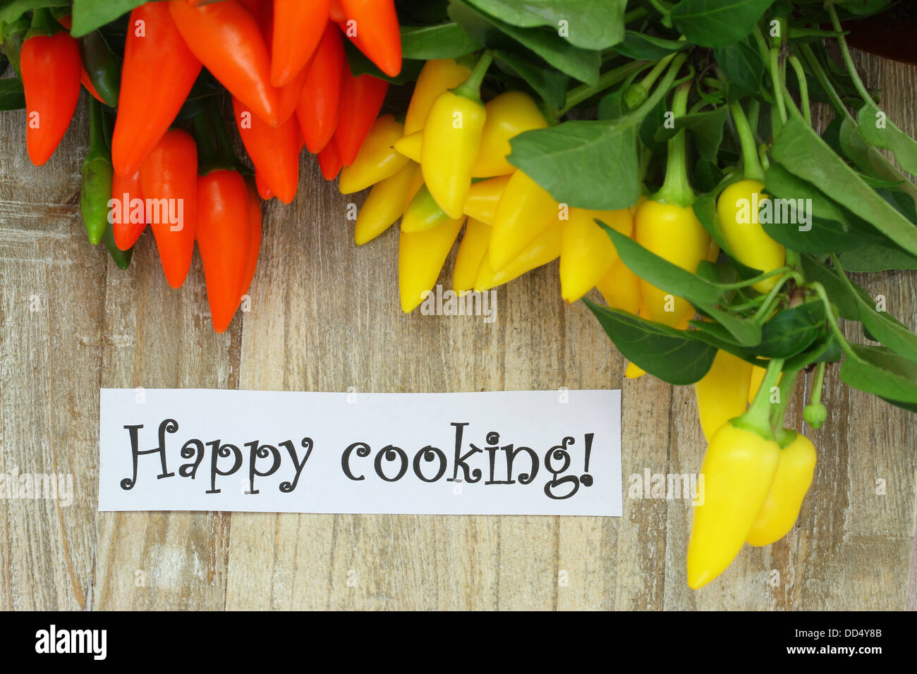 Happy cooking card with red and yellow chili peppers Stock Photo - Alamy