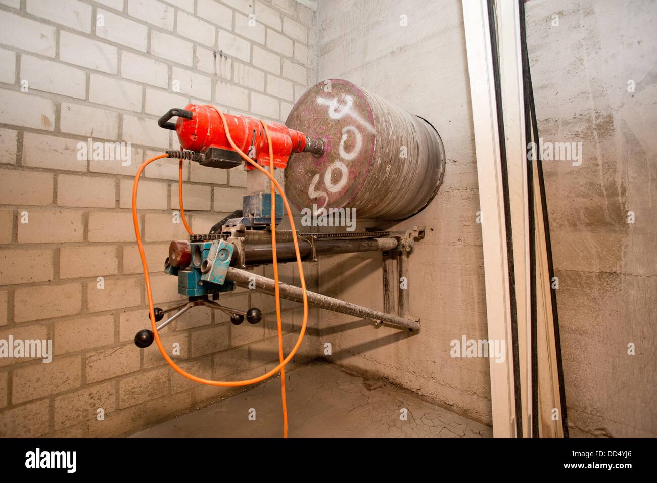 Heavy drilling rigs are pictured at a cellar wall in an apartment ...