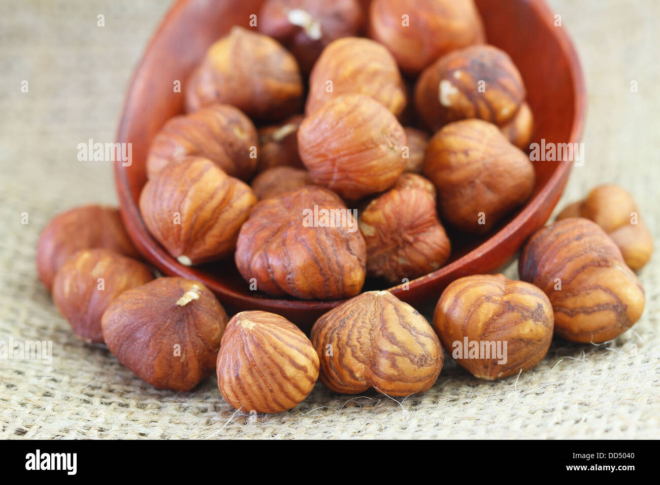 Hazelnut with and without shell on jute surface, close up Stock Photo ...