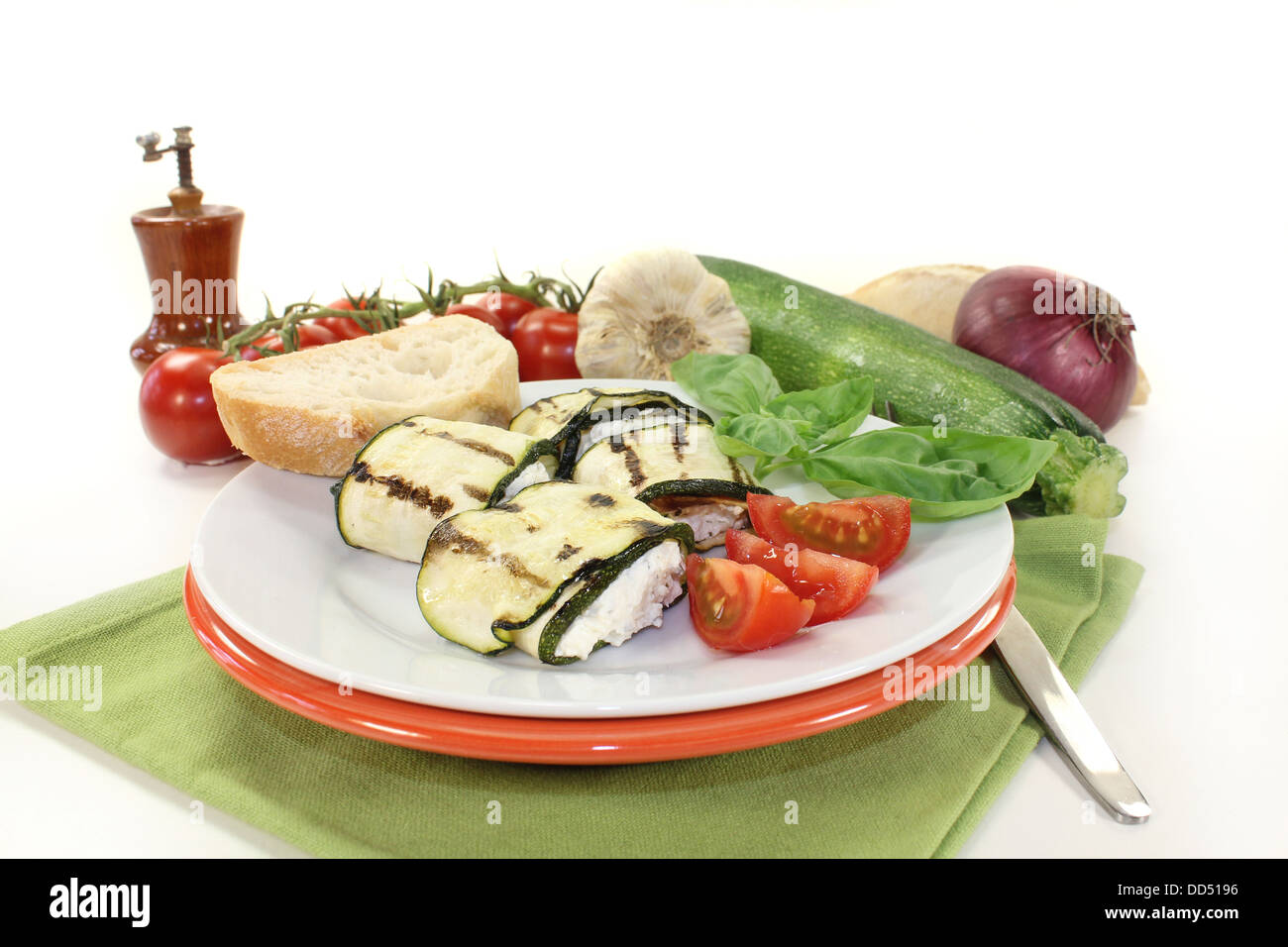 stuffed courgette rolls and tomatoes on a white plate Stock Photo - Alamy