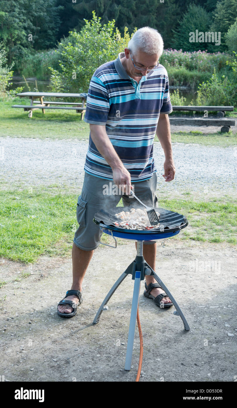 man cooking food with gas comfort on the camping Stock Photo - Alamy