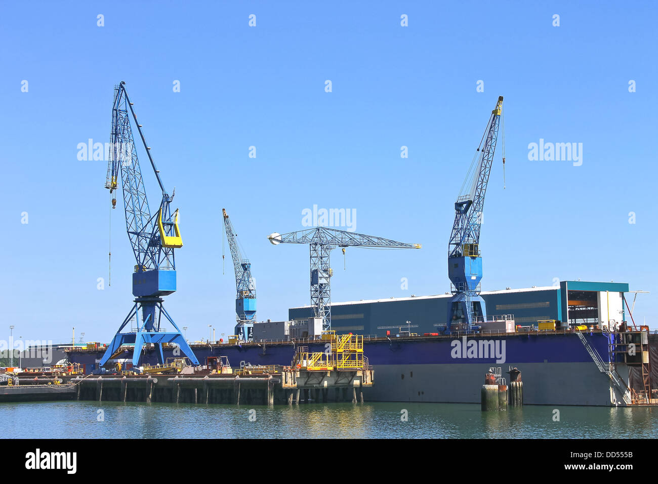 Industrial landscape. Cranes in shipyard Stock Photo - Alamy