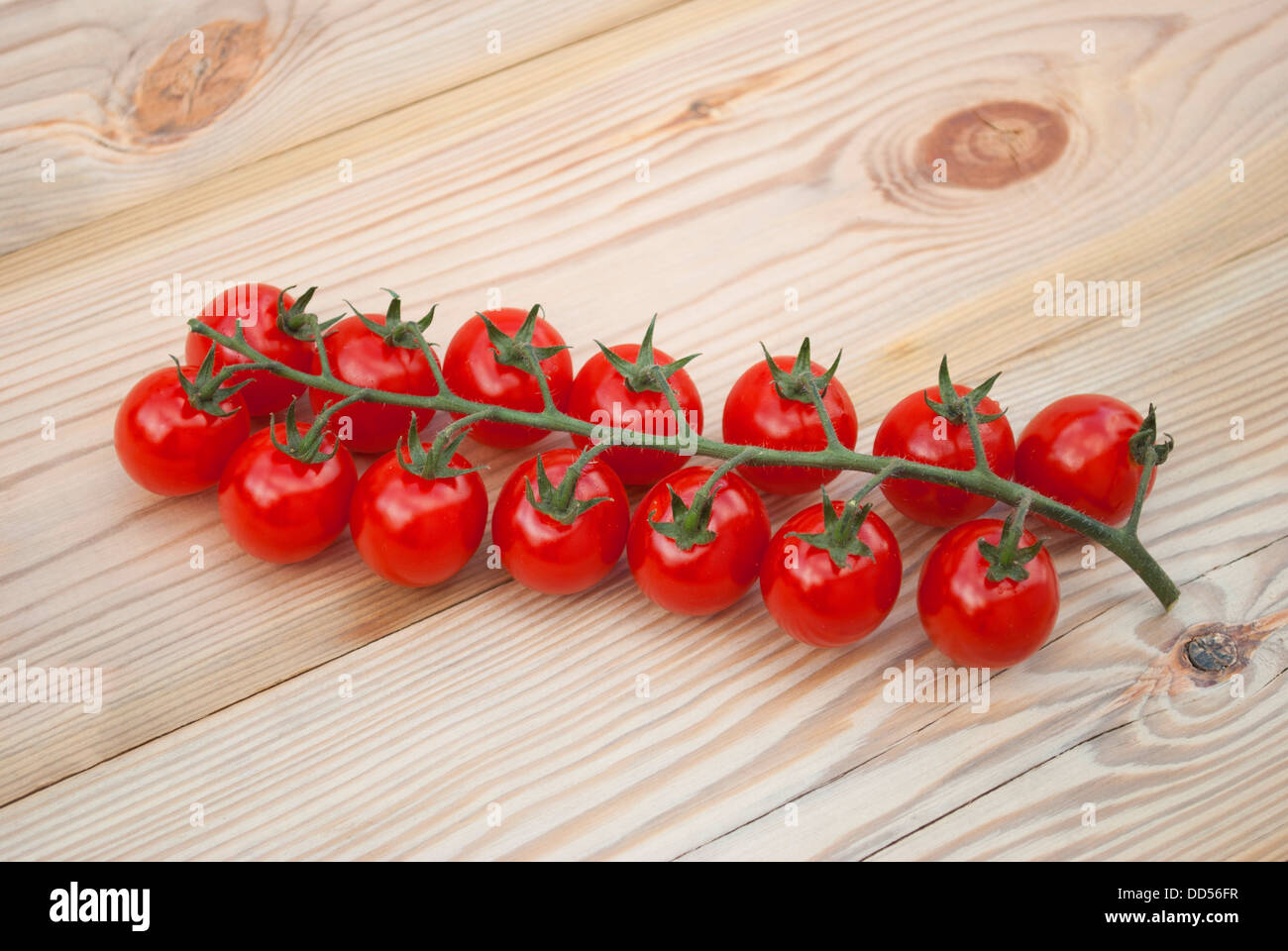 Fresh cherry tomatoes on a wooden table Stock Photo - Alamy