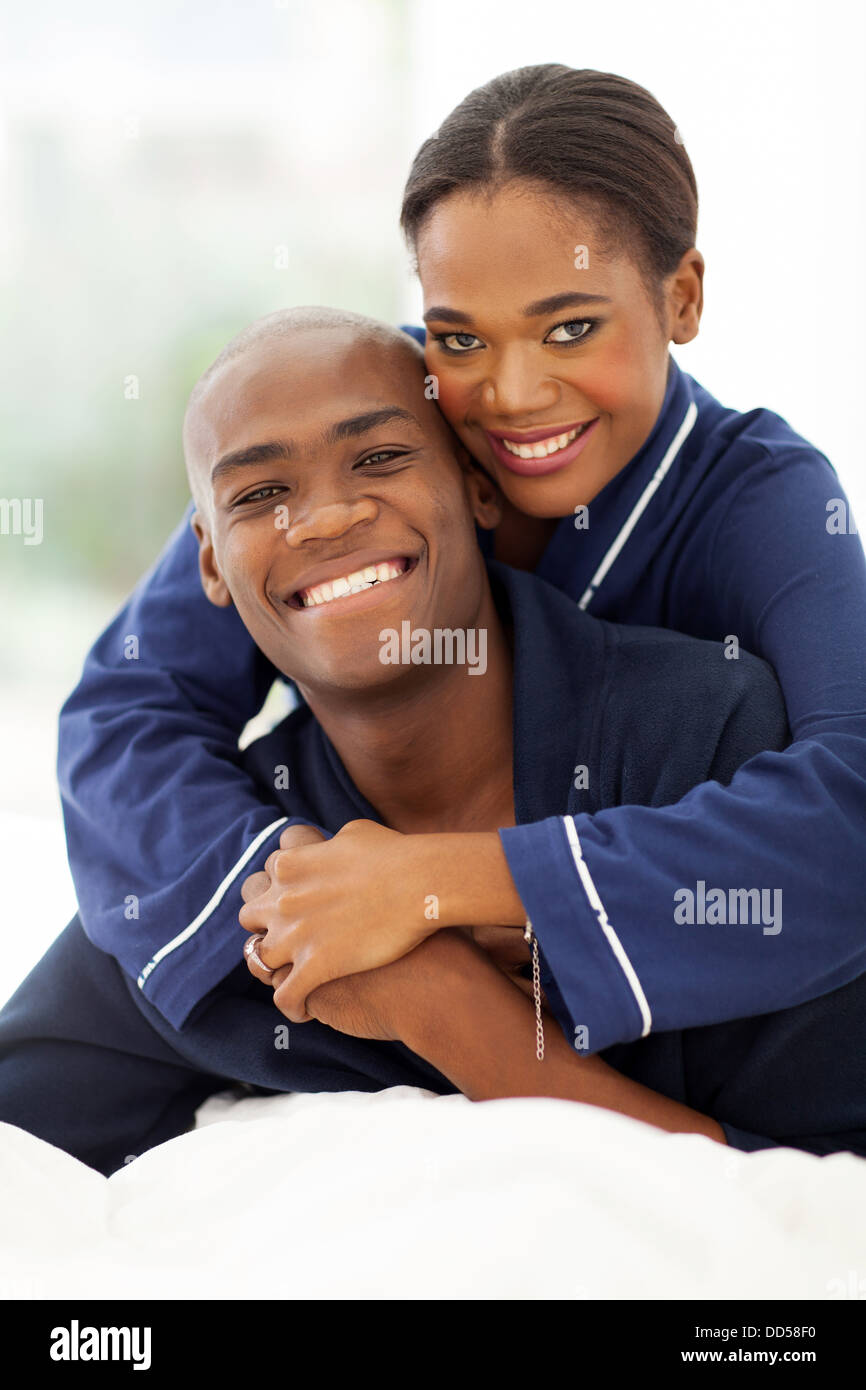 cheerful African American couple hugging in bed Stock Photo - Alamy