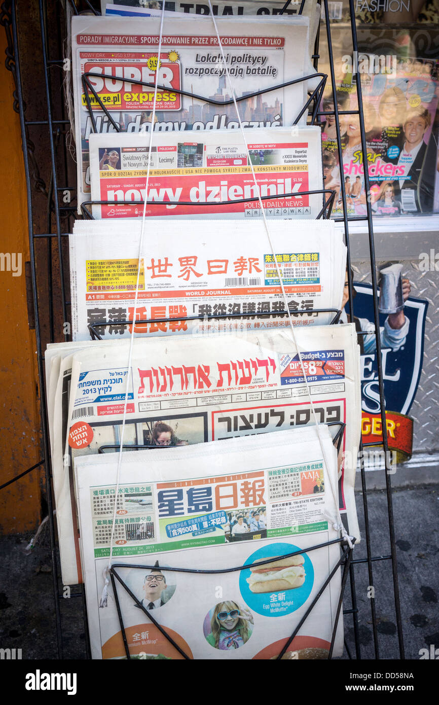 A collection of ethnic newspapers displayed at a newsstand in New York ...