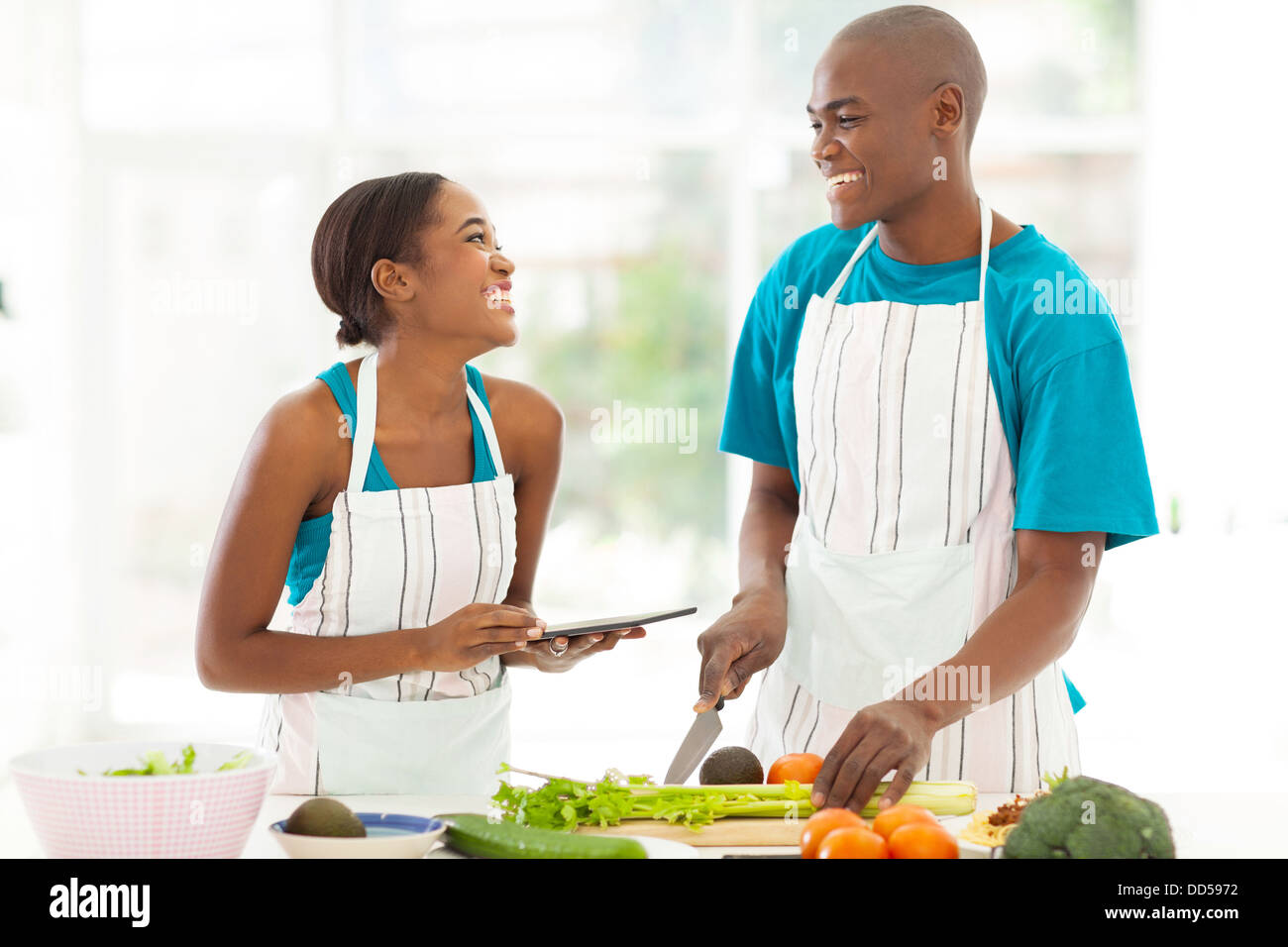 beautiful young African couple in home kitchen cooking Stock Photo - Alamy