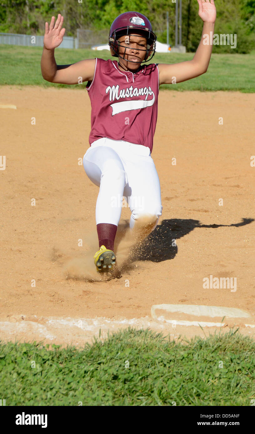 Sliding into base in a softball game Stock Photo - Alamy